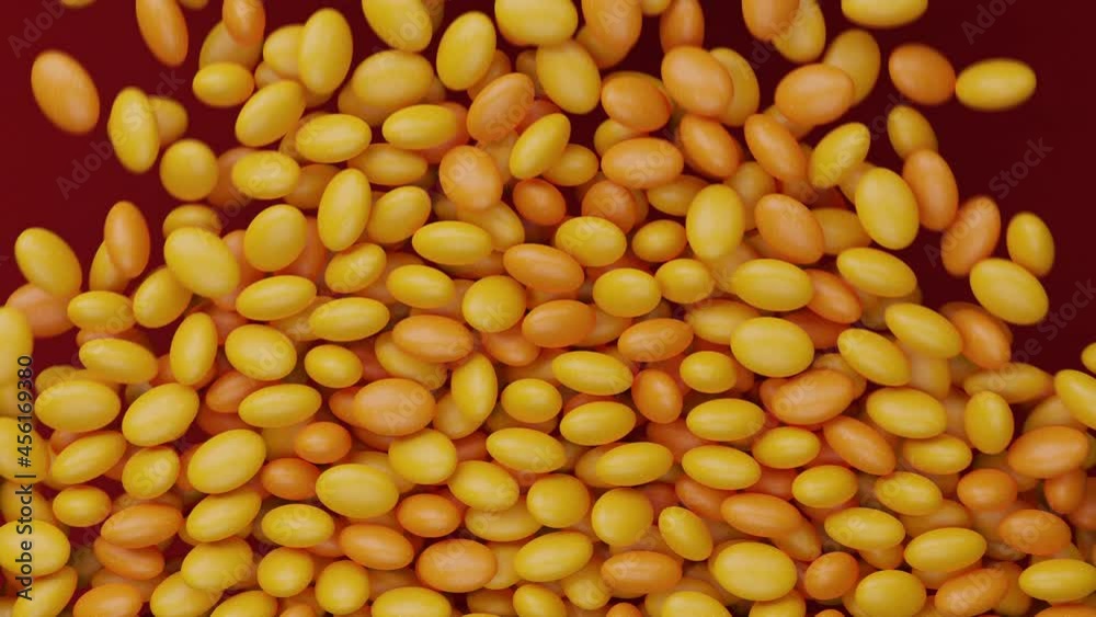 Bright and colorful candy beans or peanuts are falling down. Red ...