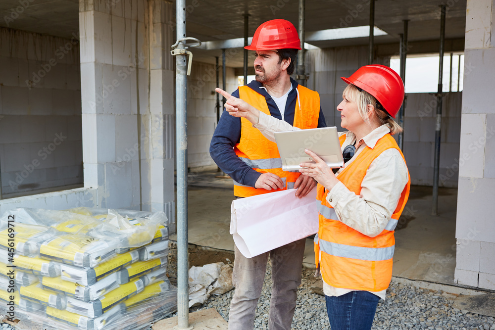 Female architect using tablet computer on a construction site Stock ...
