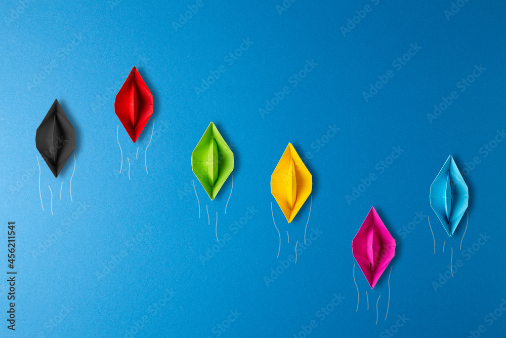 paper boat concept. boats in various colors in business competiton on ...