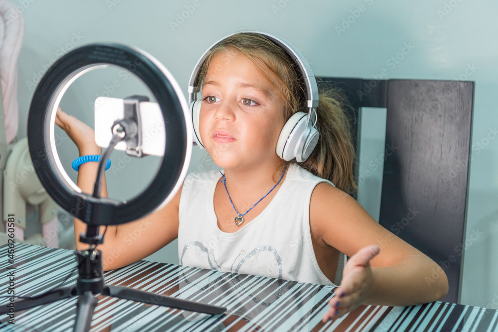 Little caucasian girl recording a video tutorial for her social media ...