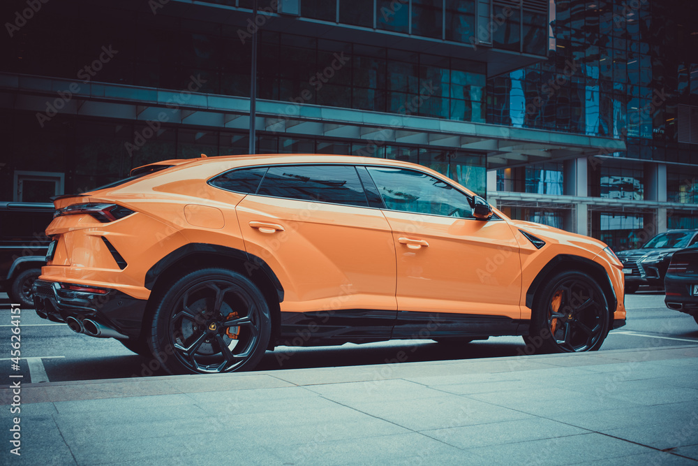 Lamborghini Urus parked on the street in Moscow. Orange supercar in ...