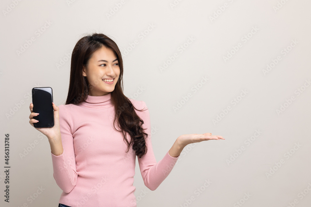 Pretty Young Asian Woman Showing Screen Of Smartphone And Palm Up Hand