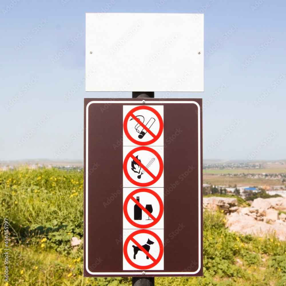 Mockup. Many prohibition signs on one poster in a summer park. Blank ...