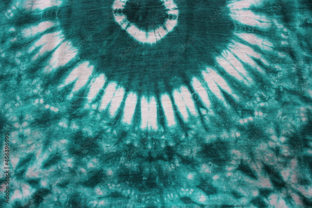 Tie dye green background with half circle layers of dye pattern fading ...
