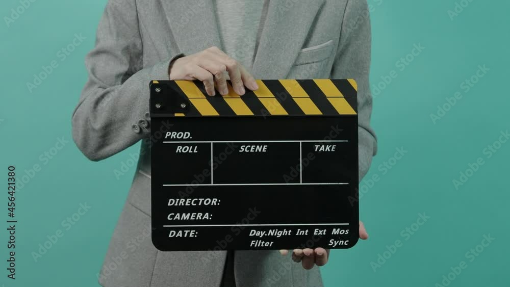 Movie slate or clapperboard hitting. Business woman holding empty film ...