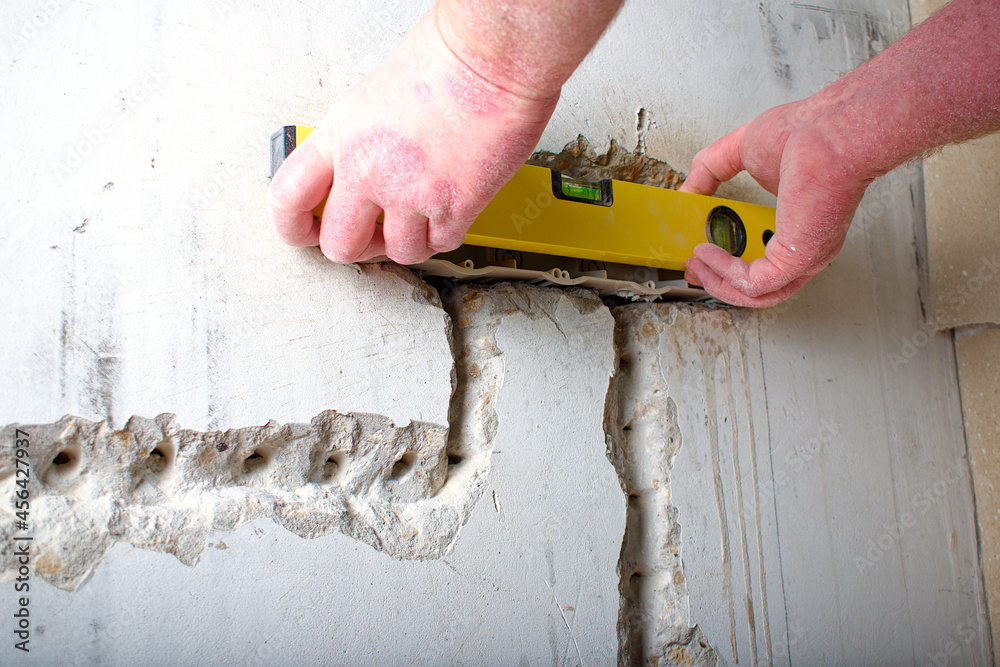 Level measurement. Installing the plastic socket box into the wall ...