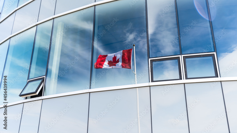 Canada flag waving in the wind and urban skyscraper architecture ...