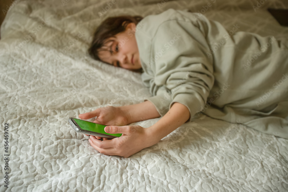 teenager girl holding phone with green screen, adolescent girl using ...