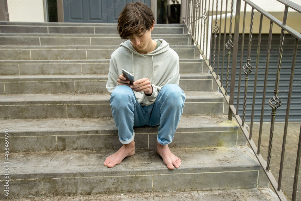 Hands of teenager boy holding phone with green screen, adolescent boy ...
