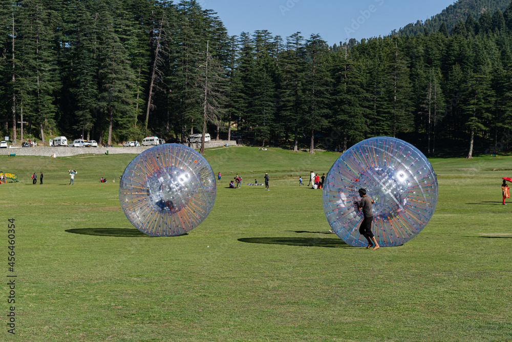 Zorbing ball. Tourist enjoying zorbing in the valley of Khajjiar in ...