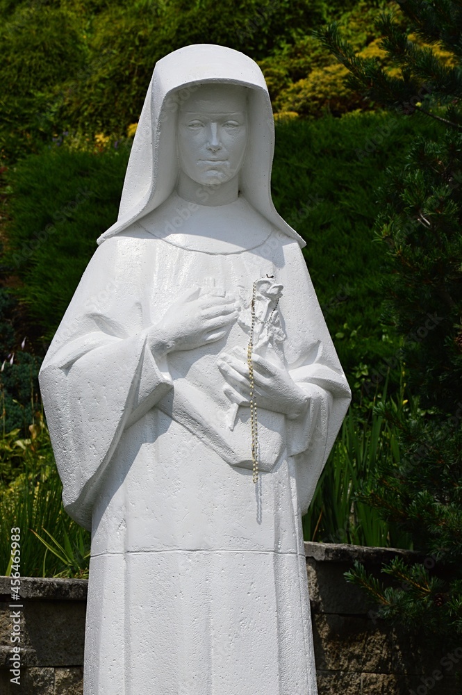 Statue of polish Saint Faustyna Kowalska holding cross and rosary ...