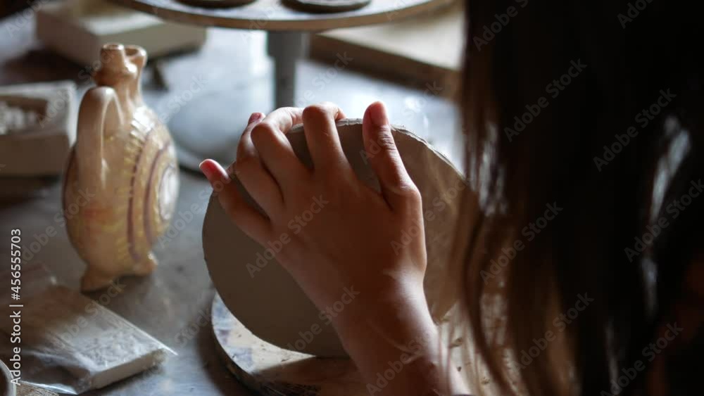 Traditional pottery. A close-up shot of making a traditional plate ...