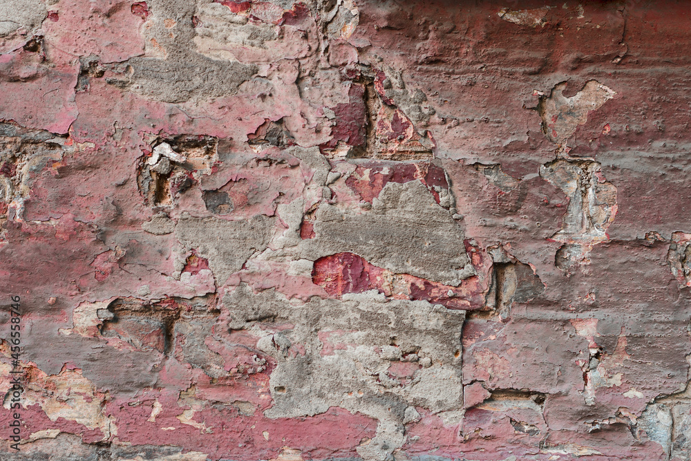Aged brick wall. Wall covered with faded paint. The wall is covered ...