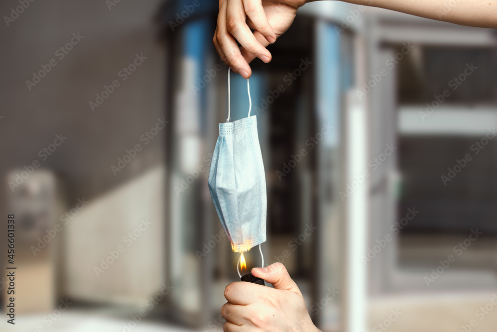 burn medical face mask to end the corona measures as symbol against ...