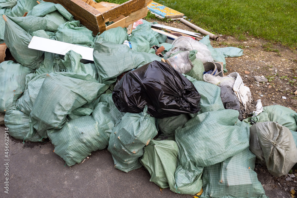Construction garbage. Garbage bags next to lawn. Waste from ...