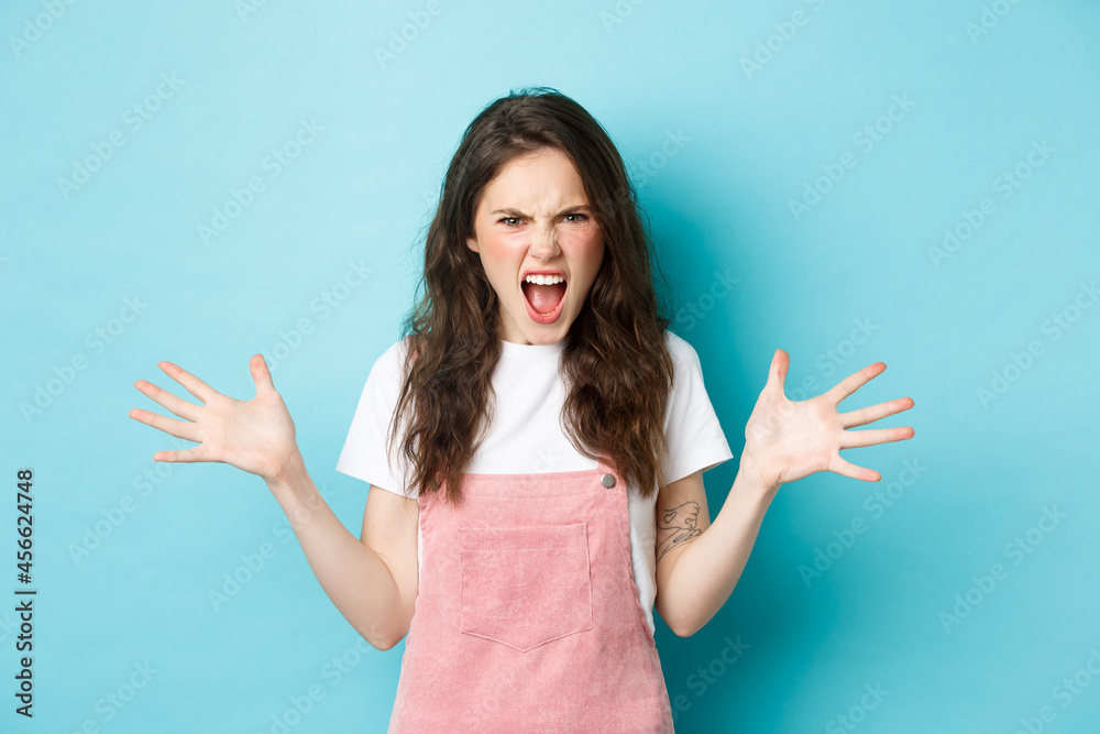 Angry brunette woman in summer outfit, shaking hands and yelling ...