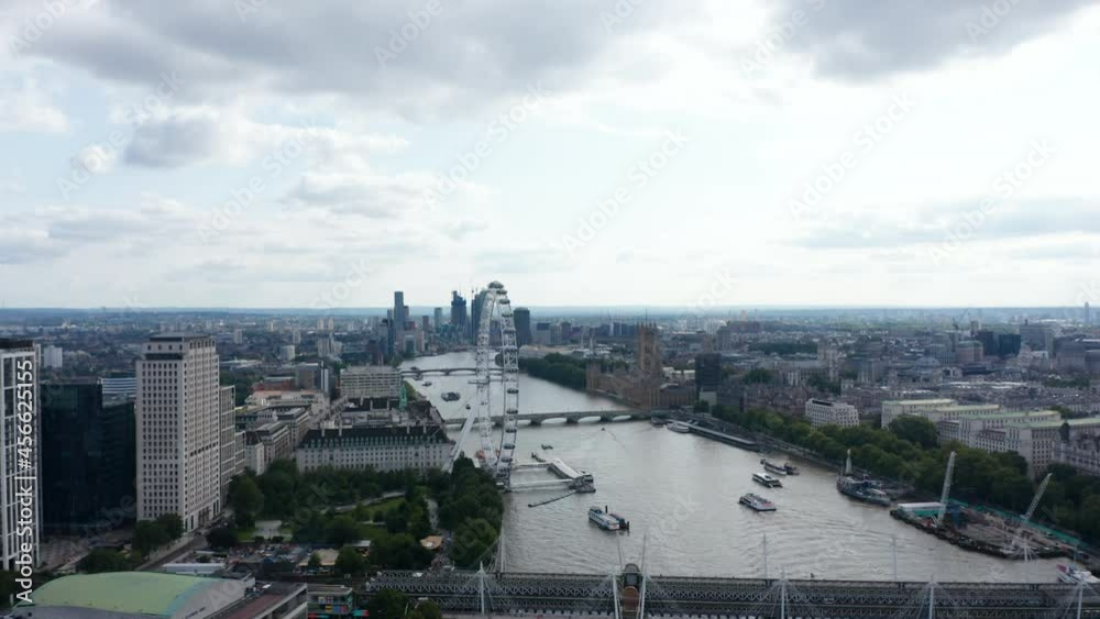 Crane footage of wide river flowing through large city. Thames river at ...