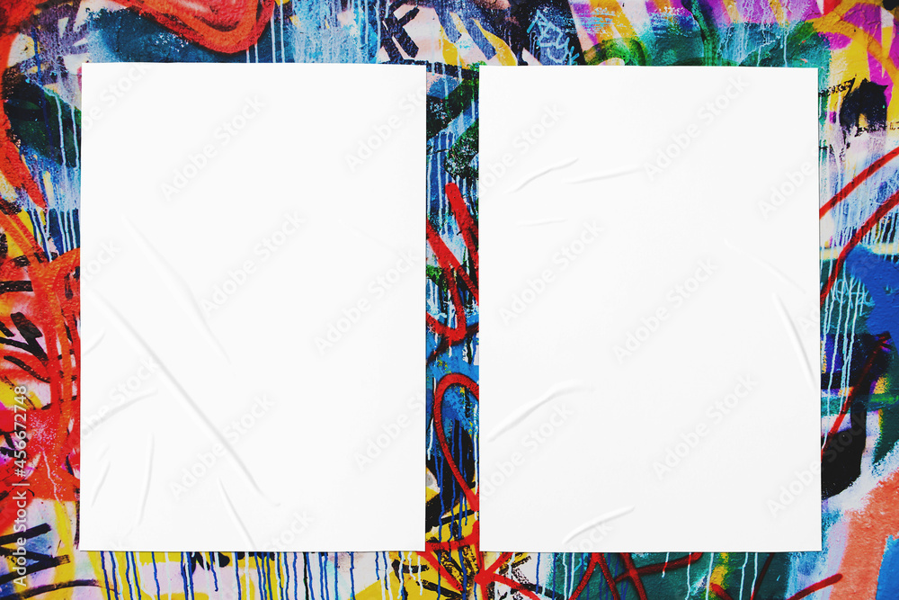 Closeup of colorful messy painted urban wall texture with two wrinkled ...