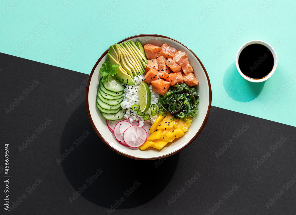 Delicious poke bowl with rice, mango, avocado, radish, chukka salad ...