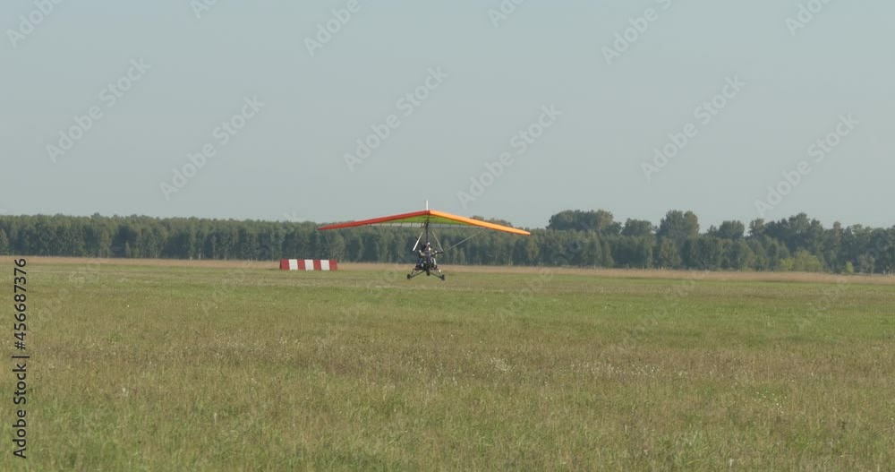 Gliding, training flights. A hang glider with a pilot and a passenger ...