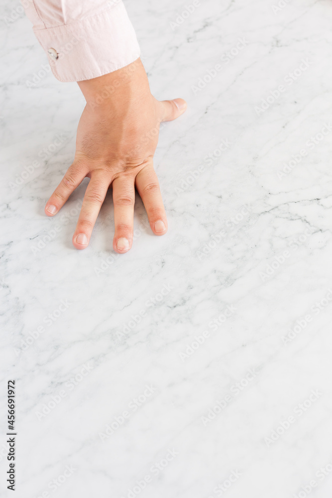 Hand resting on marble texture with empty space. Graphic design ...