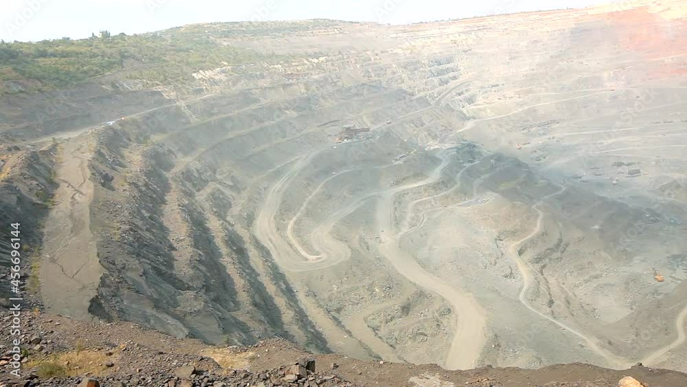 Coal mining in an open pit panorama. Coal mining machines in an open ...