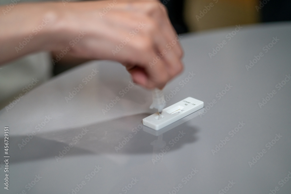 Asian woman using rapid antigen test kit for self test COVID-19 ...