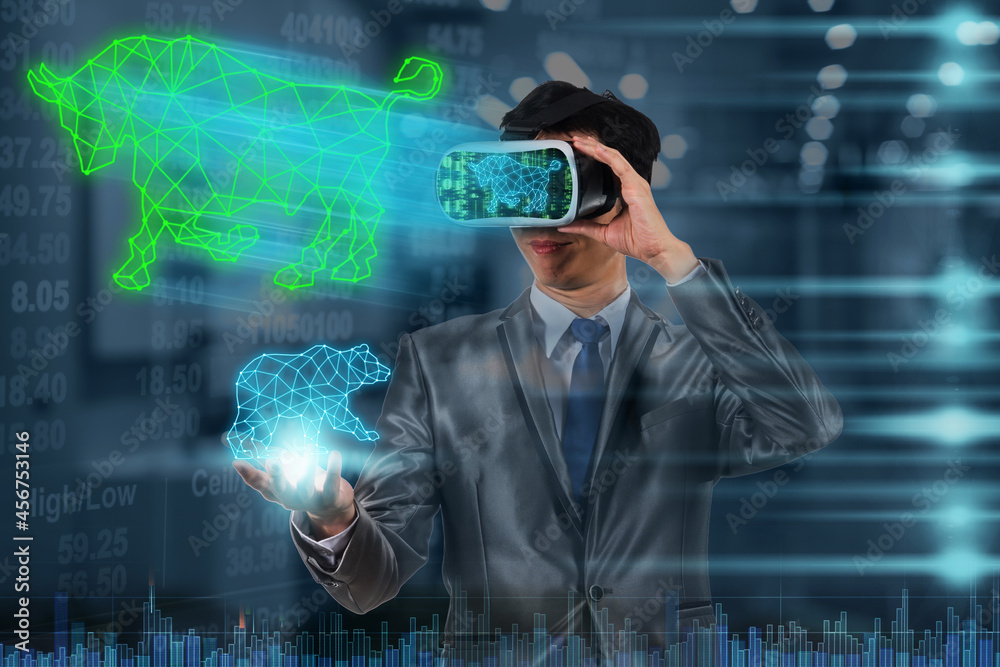 Asian Businessman using virtual reality glassed and hand holding Bull ...