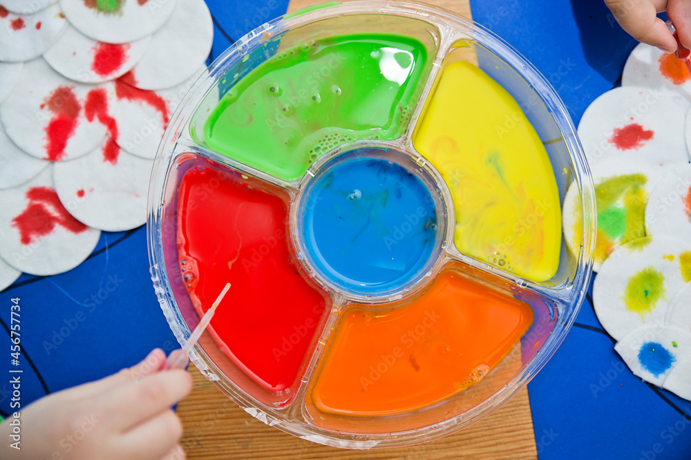 Fish made of cotton pads and paint by mother and kid. Boy coloring with ...