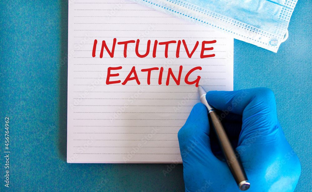 Intuitive eating symbol. White note with words Intuitive eating ...