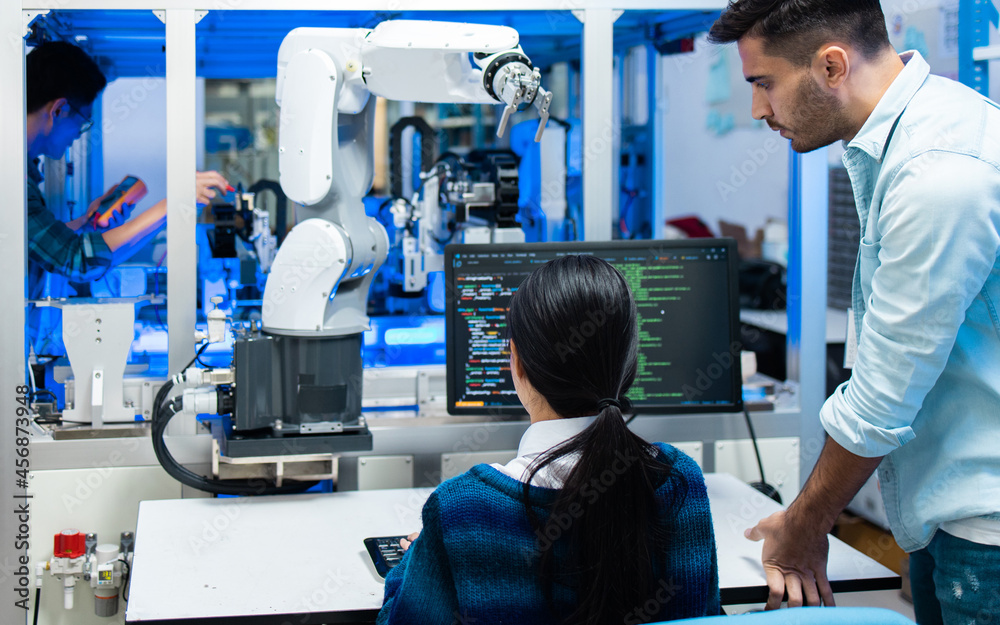 Meeting asian Engineers Maintenance Robot Arm at Lab. they are in a ...