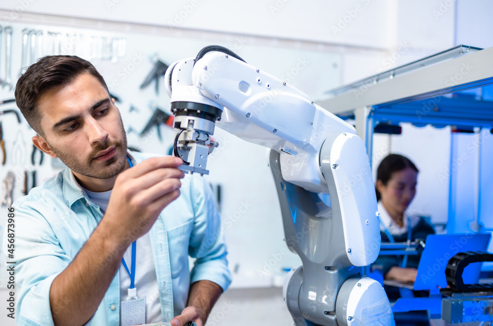 Engineers Maintenance Robot Arm at Lab. he are in a High Tech Research ...
