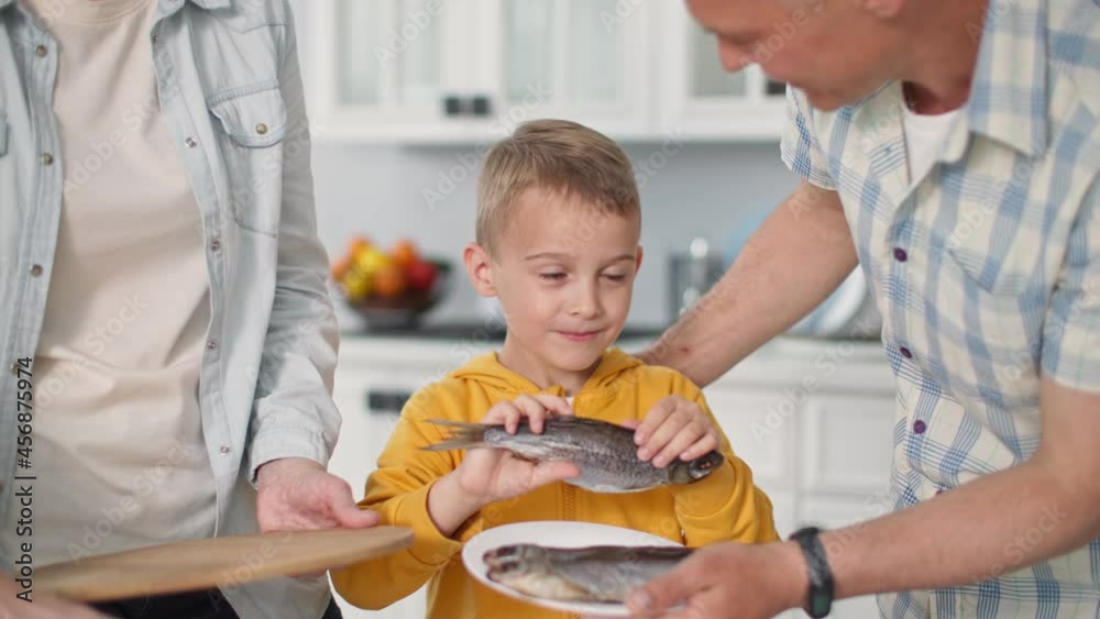 seafood, joyful little boy chooses fish for snack with mom and dad at ...