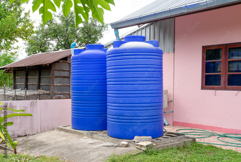 Blue plastic water tanks. Stock Photo | Adobe Stock