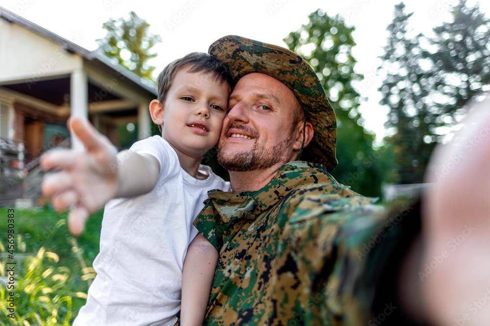 Man in military uniform making a selfie with smartphone with his lovely ...