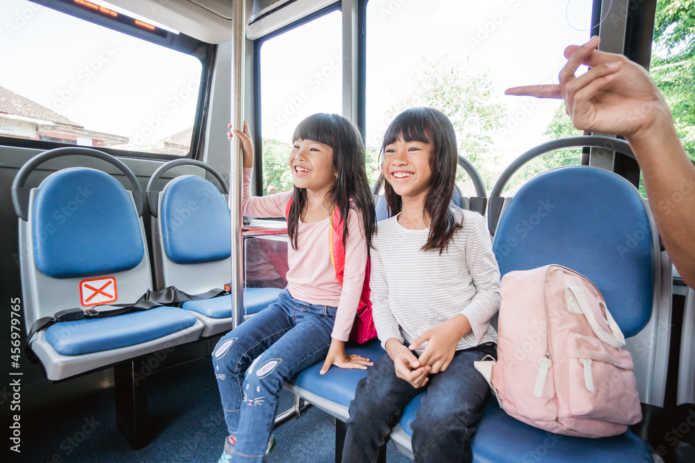 two asian primary student going to school by bus public transport Stock ...