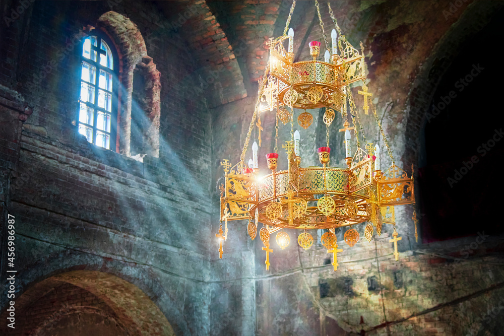 Rays of light in an ancient stone church. The sun's rays in dark stone ...