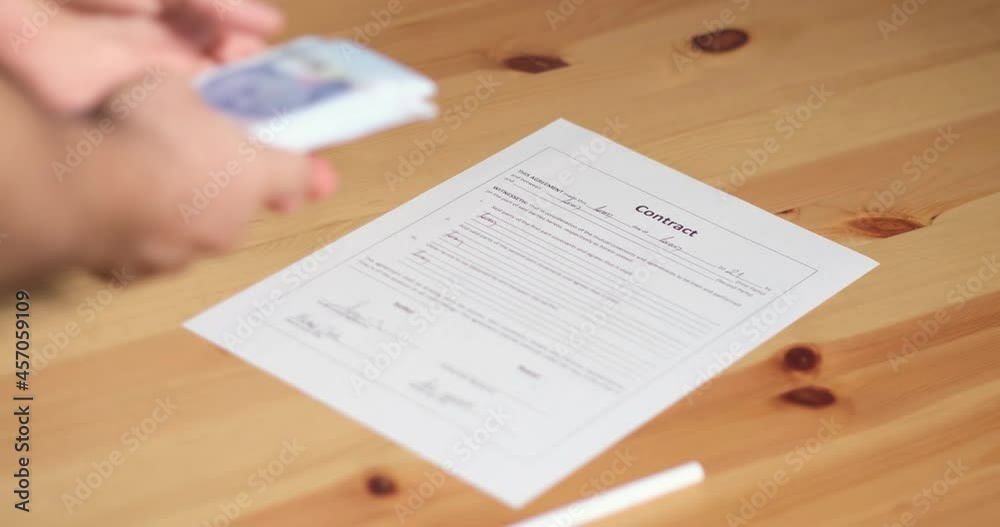 Business man count money and signing a contract, legal agreement, or ...