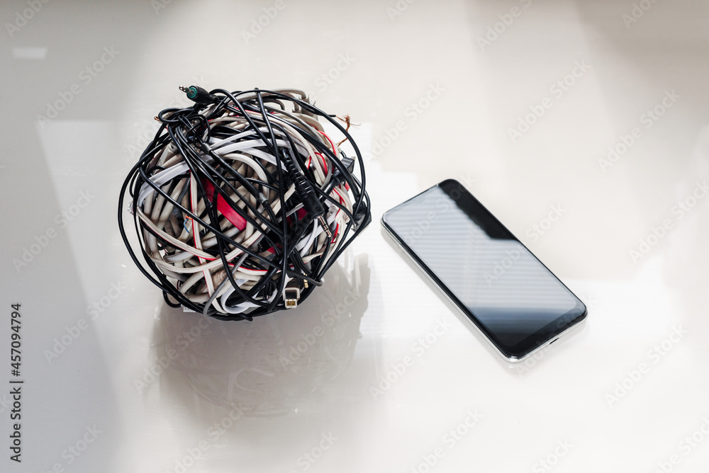 Modern mobile phone with messy bunch of different cables, future ...
