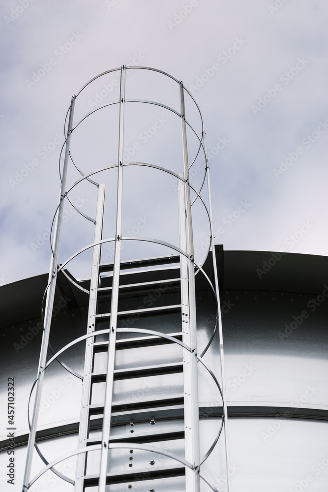 Industrial metal ladder with round railing Stock Photo | Adobe Stock