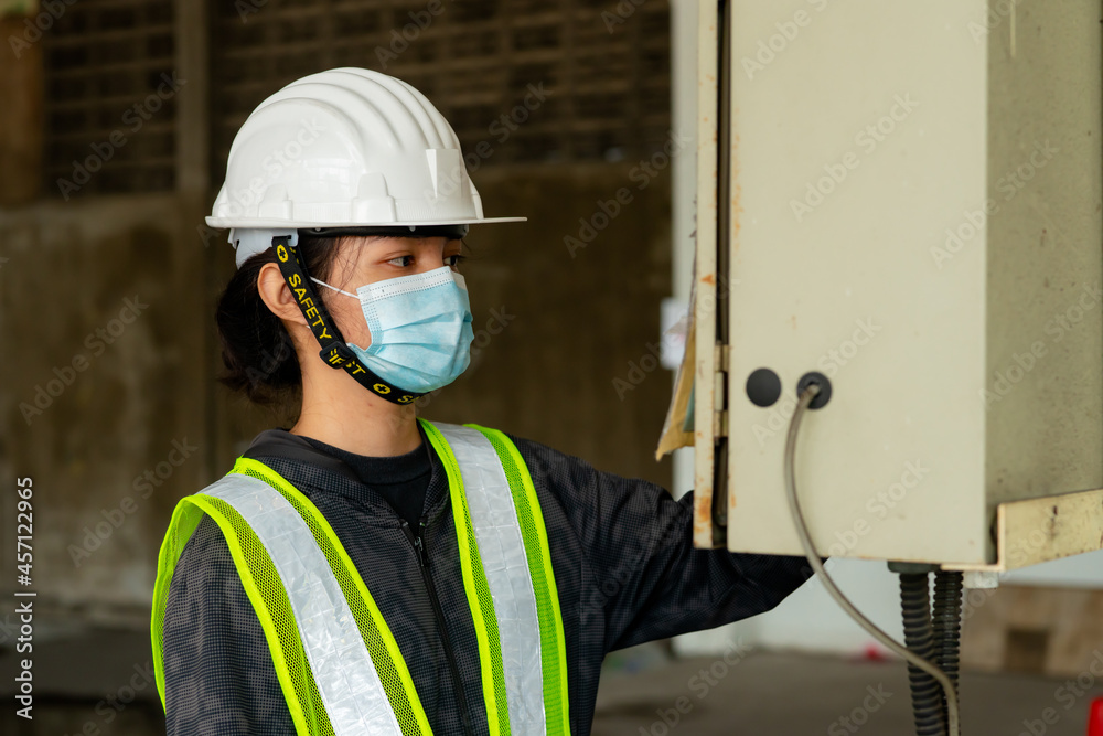 Young Asian female engineer wearing a medical mask to cover her mouth ...
