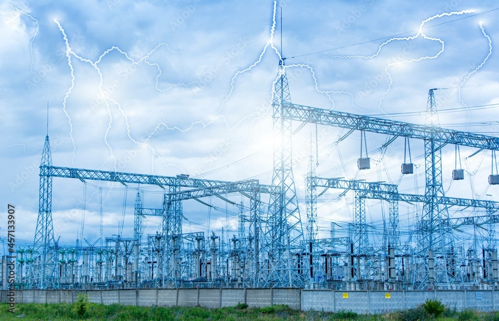 An electrical substation transmits electricity through a power line ...