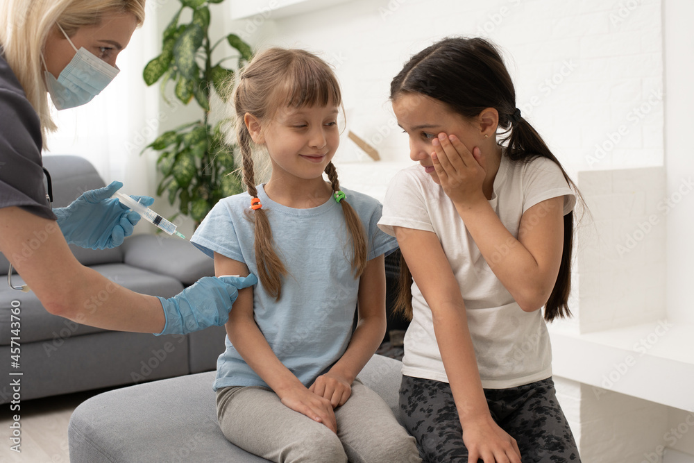 nurse giving vaccination injection to little girl patient Stock Photo ...