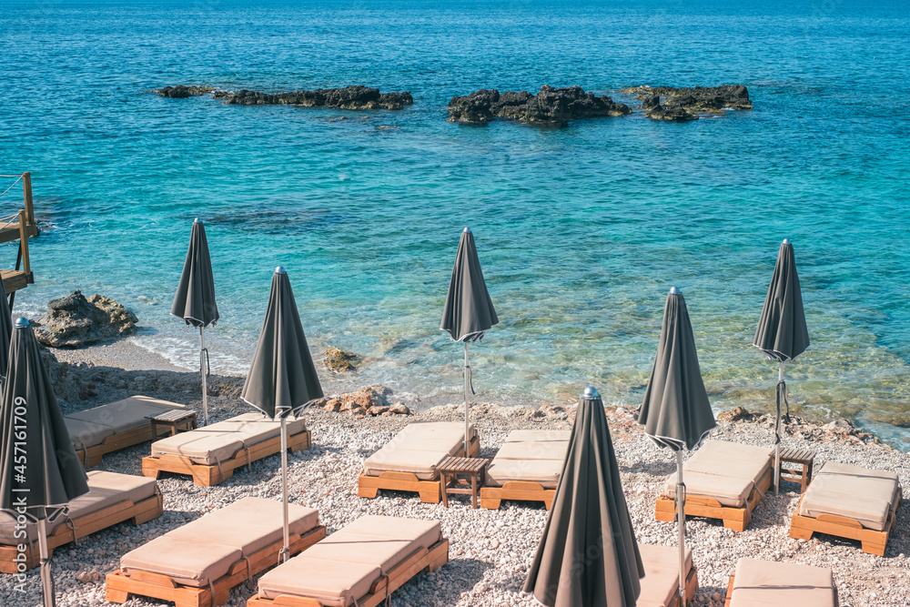 Tranquil view to Dhermi beach turquoise water and umbrellas. Summer ...