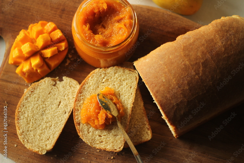Slice of home baked wheat bread with a spread of home made alphonso ...