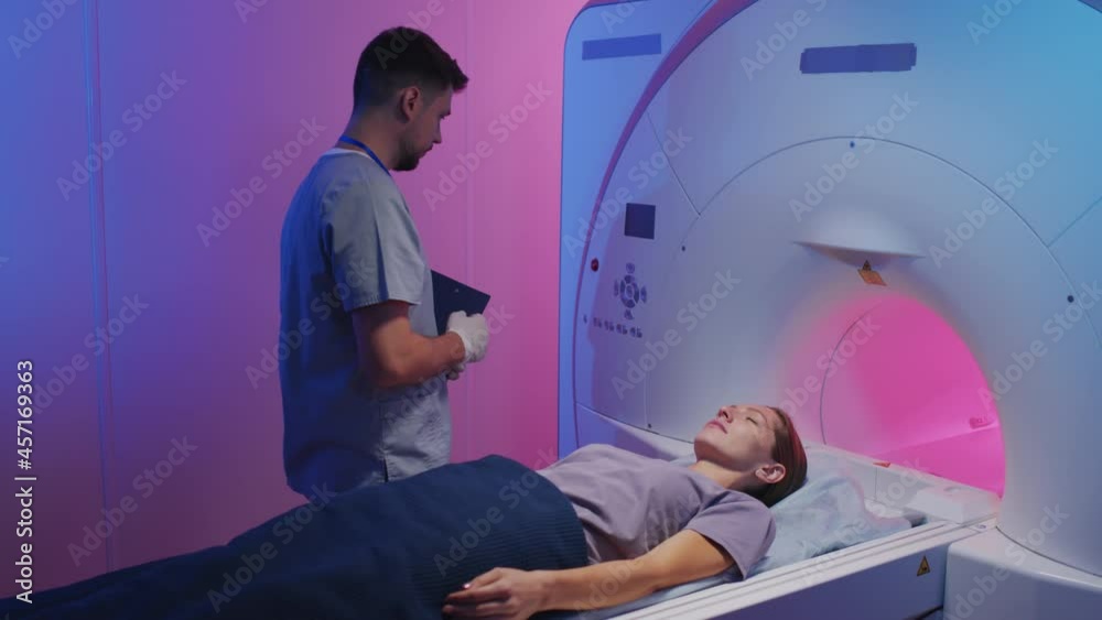 Stab shot of MRI technician pressing buttons on control panel of MRI ...