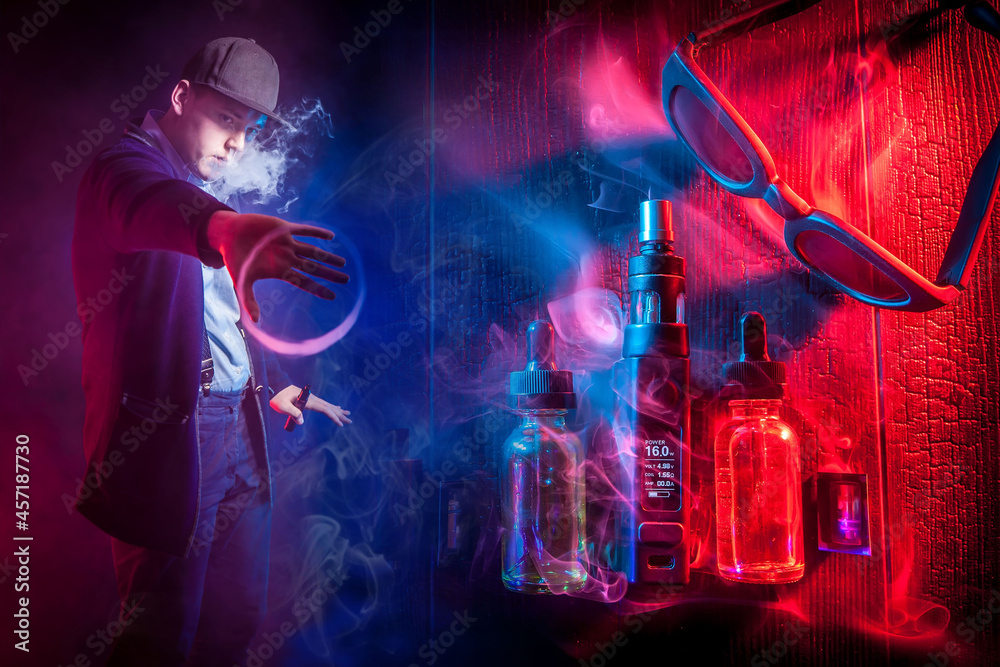 Vape pen. Vapers. Vaping. Vaper man makes a smoke ring. Vaper makes ...