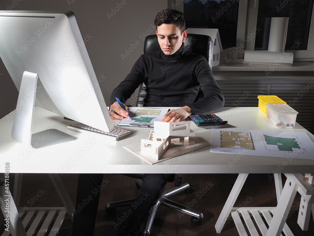 Architect draws construction drawings. Architect works in his own ...