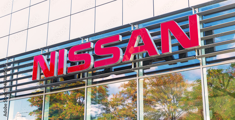 Nissan brand logo on a car dealership building emblem, symbol close-up ...