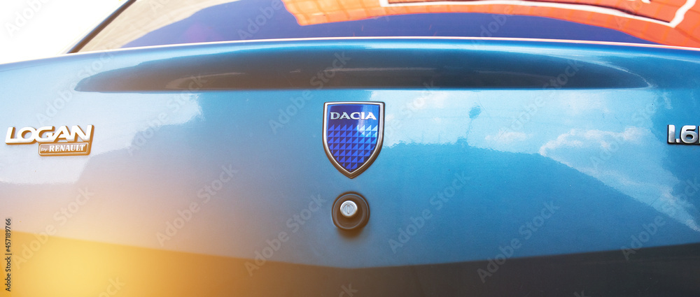 Dacia brand logo on a blue car background, emblem, symbol close-up ...